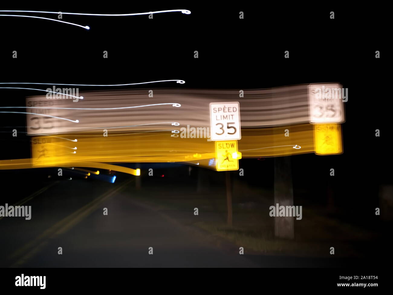 Distorted night view of street lamps and traffic signs from drunk ...