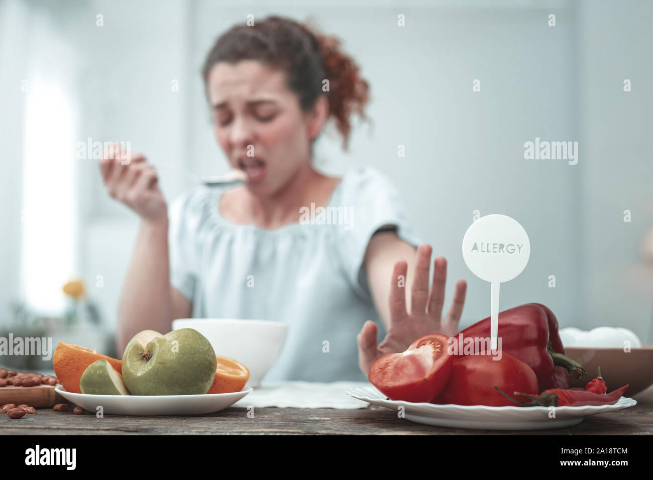 Curly woman having skin rash because of red vegetables Stock Photo - Alamy