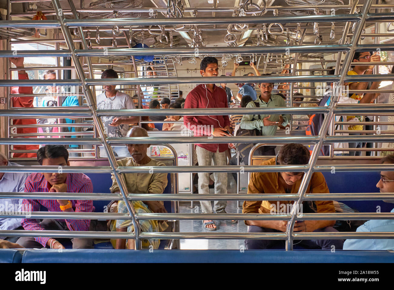 Passengers in the 2nd class compartment of a local train in Mumbai ...