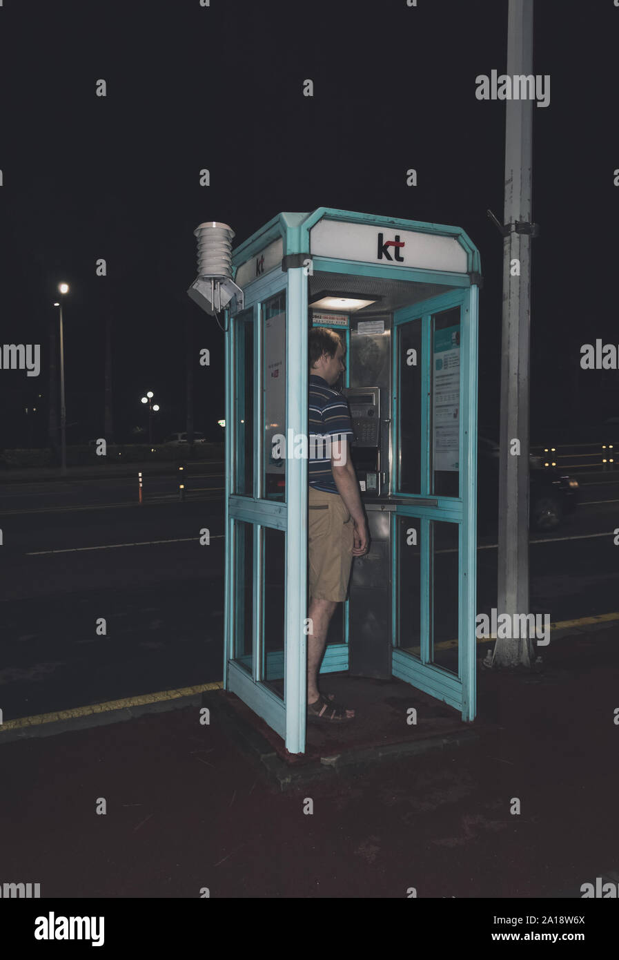 Phone booth night man hi-res stock photography and images - Alamy