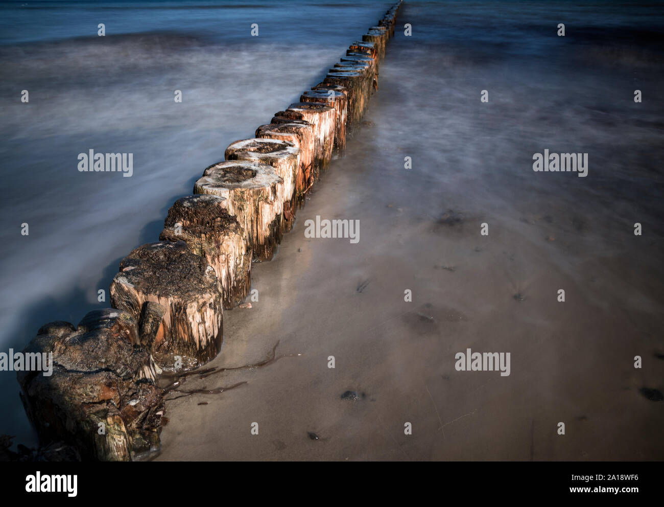 wooden groynes as coast protection in the sea, smooth water by long ...