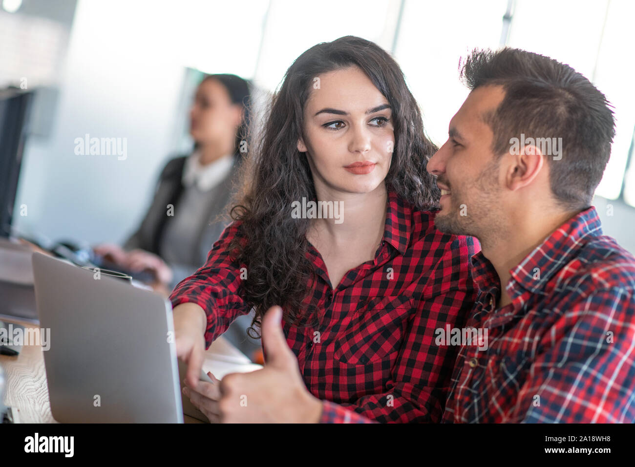 Happy business partners working on laptop. Teamwork, co-working ...