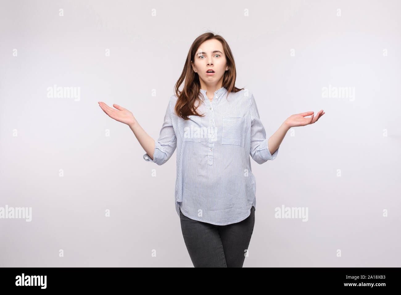 Brunette woman showing puzzled reaction.Studio portrait of brunette ...