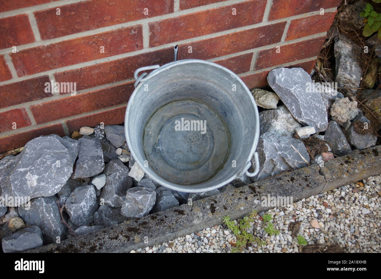 An empty garden bucket of metal without water Stock Photo - Alamy