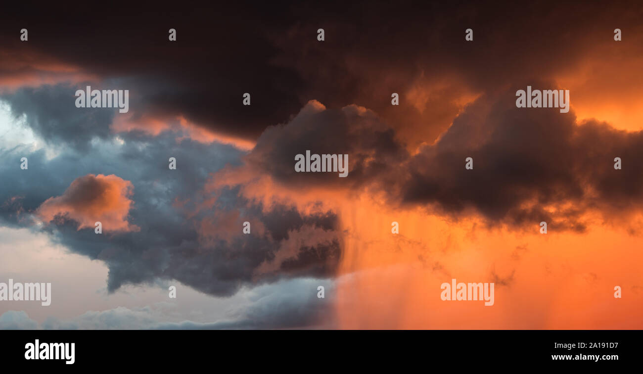 Sunset through orange colour heavy rain weather phenomenon Stock Photo ...