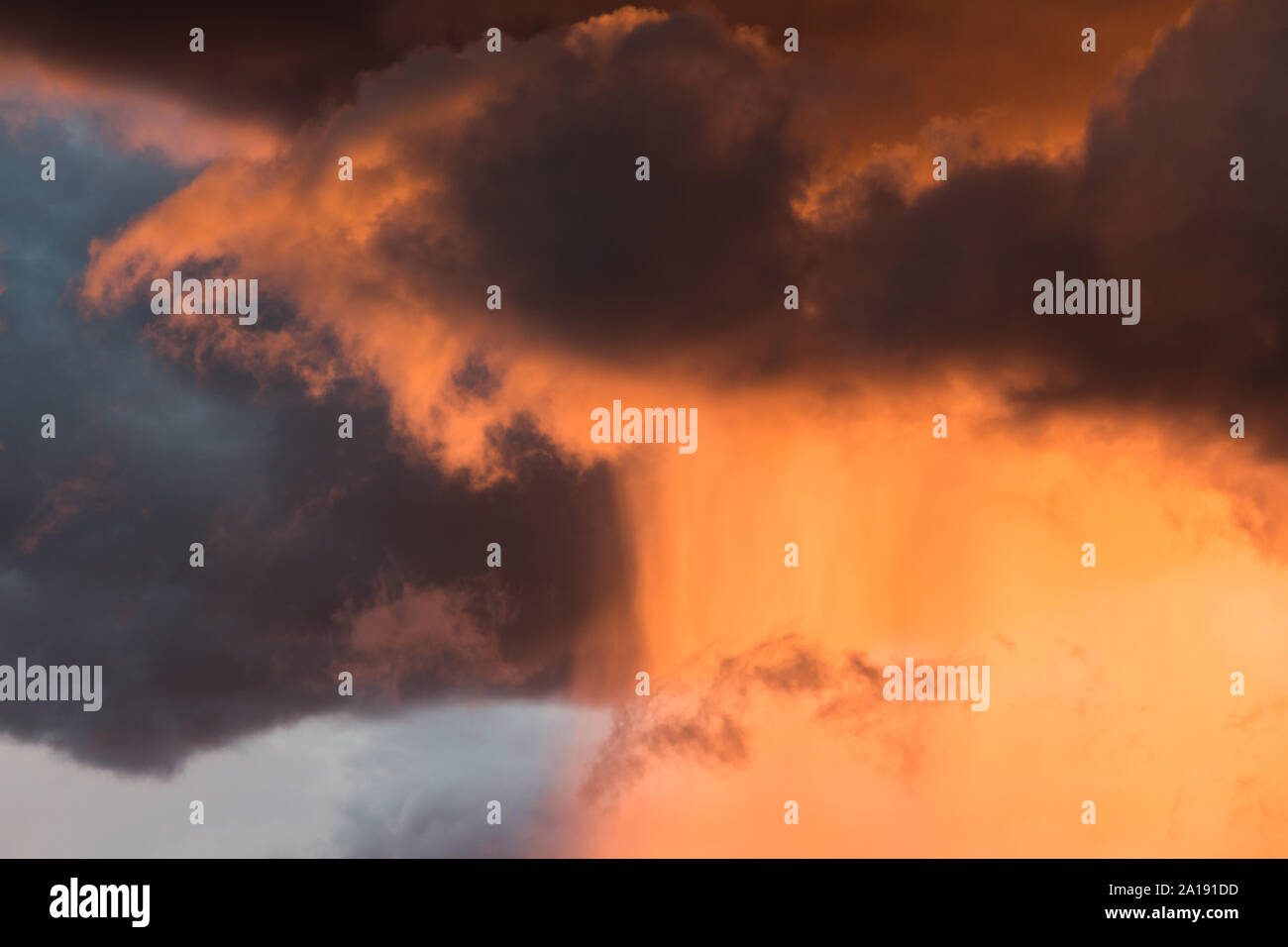 Sunset through orange colour heavy rain weather phenomenon Stock Photo ...