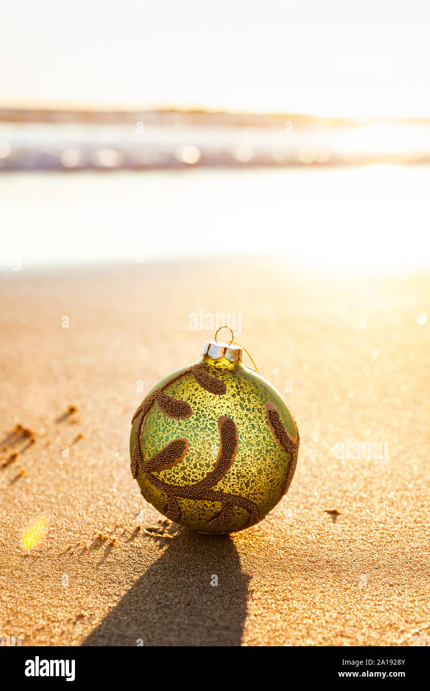 Green ball at golden sunset on the beach in California, season holiday ...