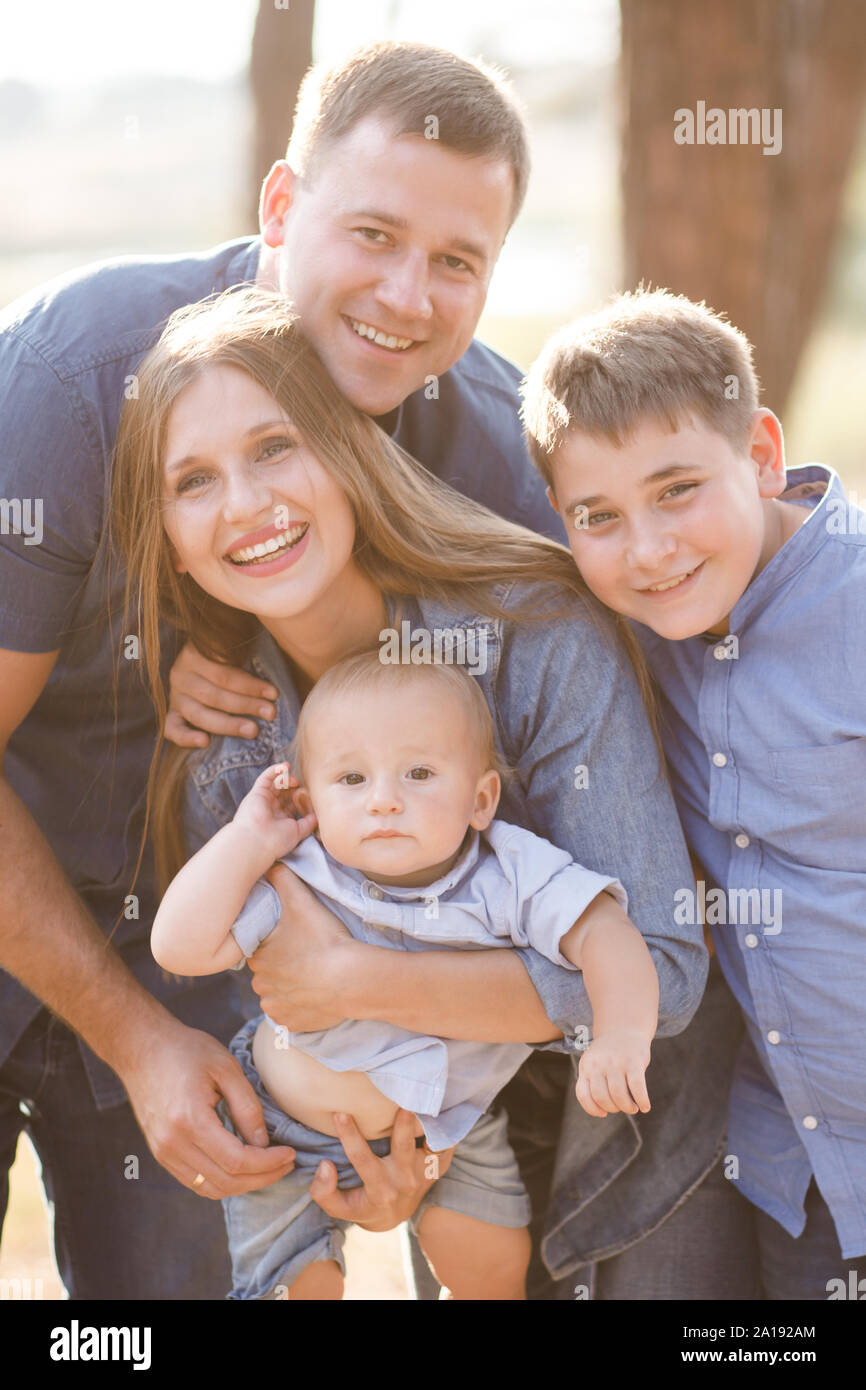 Cute young family, happy spending time together in nature Stock Photo ...