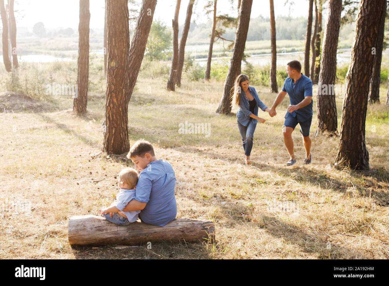Cute young family, happy spending time together in nature Stock Photo ...