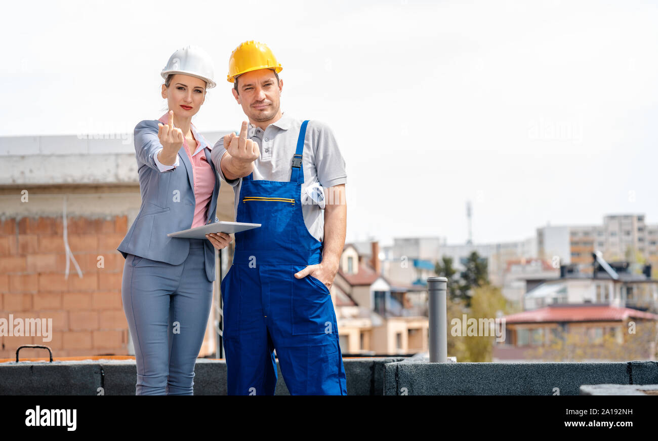 Architect and Construction worker on site giving the finger Stock Photo ...