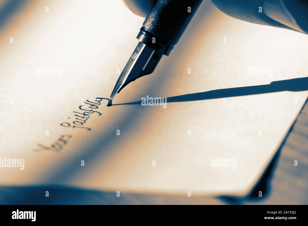 Man writing yours faithfully on the bottom of a letter with a fountain ...