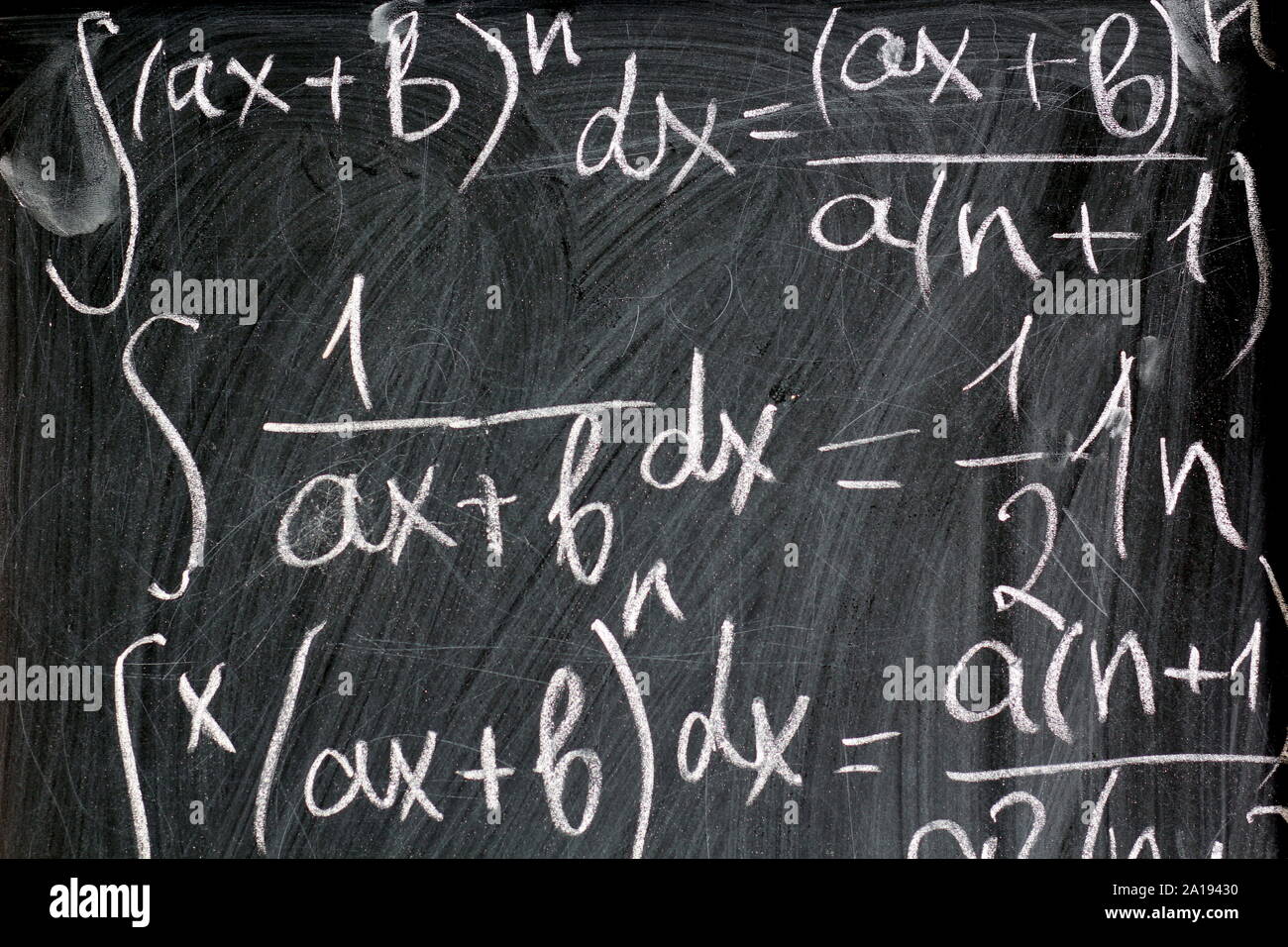 Math formulas written in chalk on school background, close up Stock ...