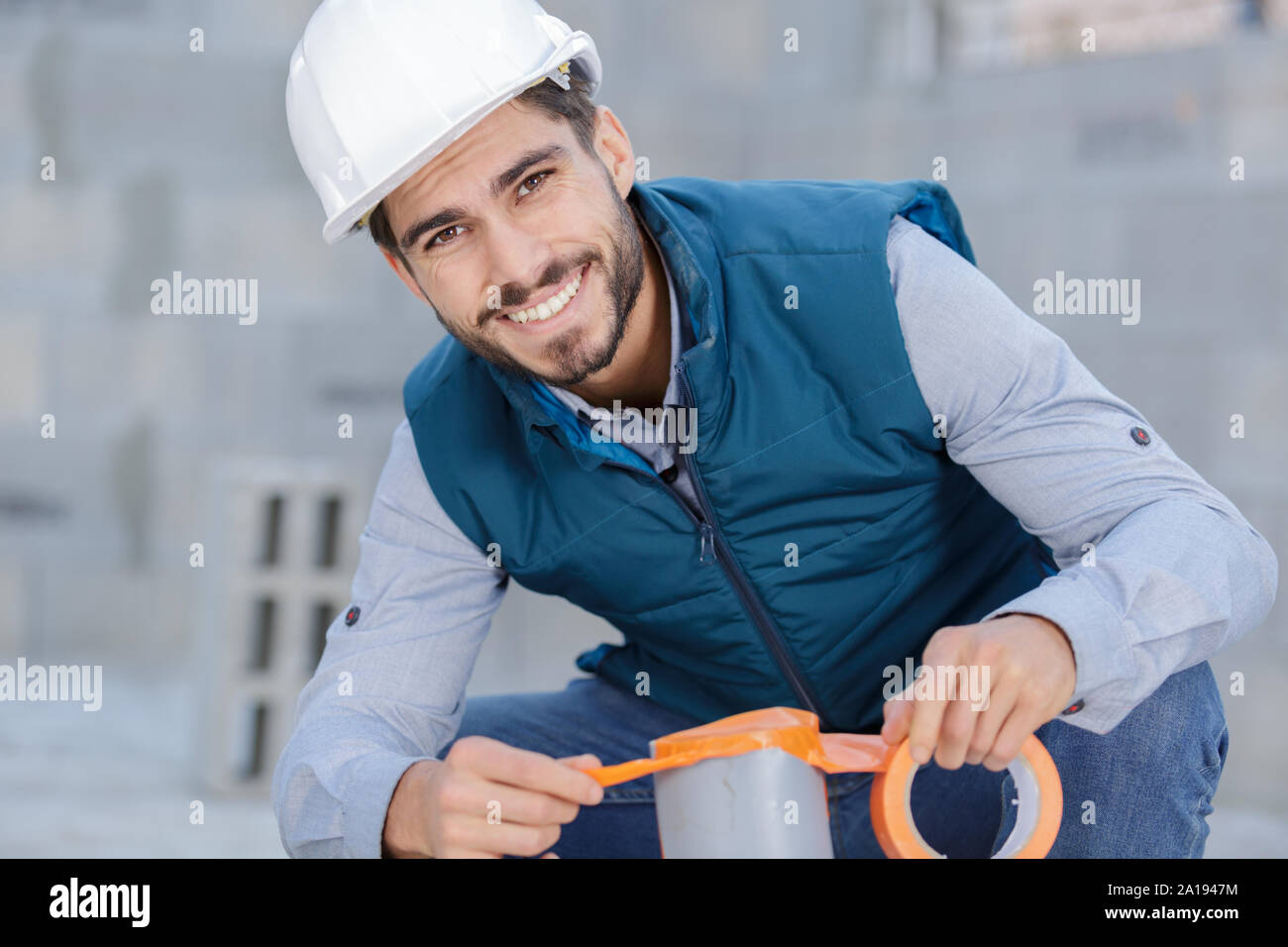 happy young man working in a construction site Stock Photo - Alamy