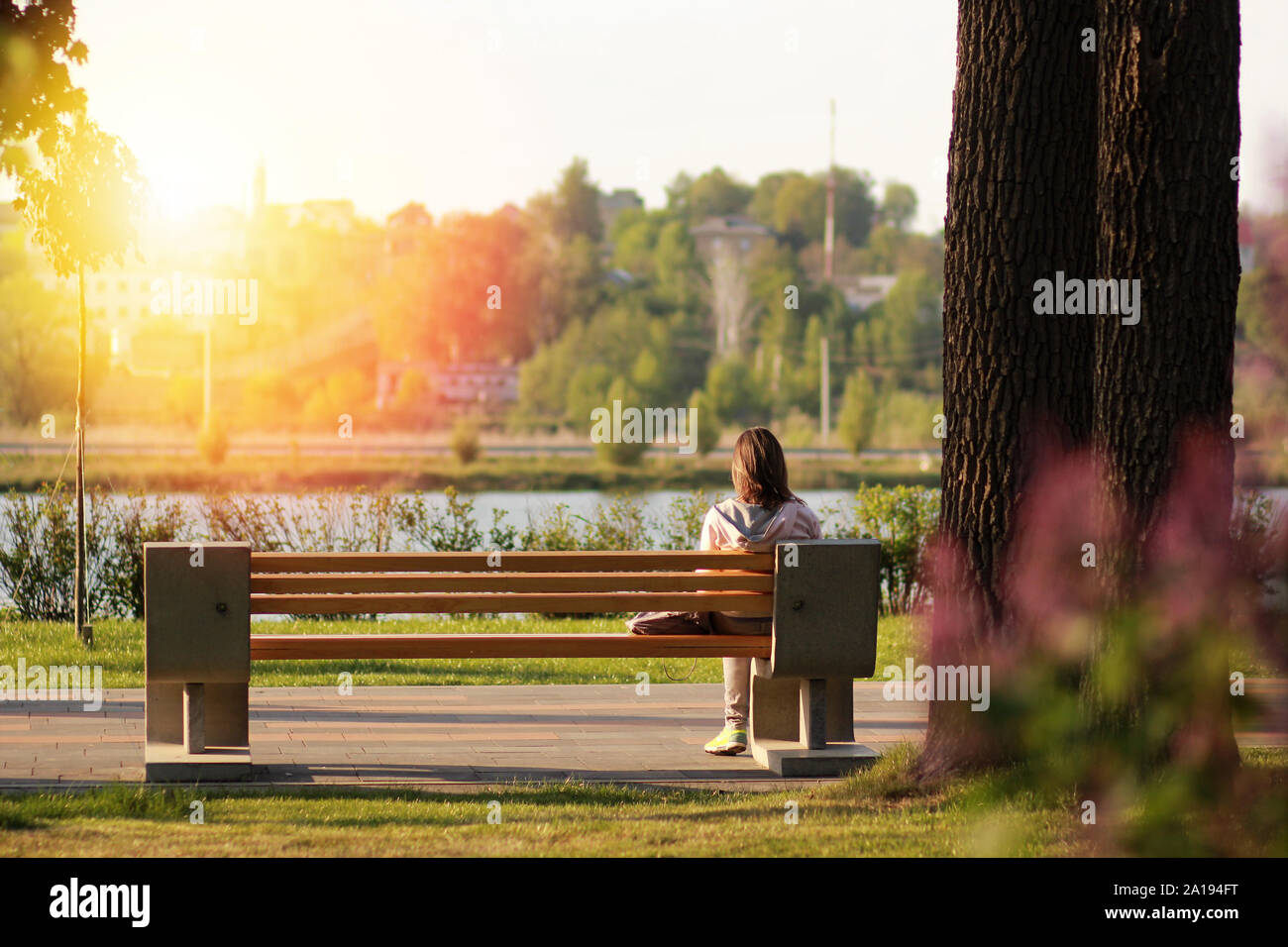 Woman sitting alone on sunset hi-res stock photography and images - Alamy