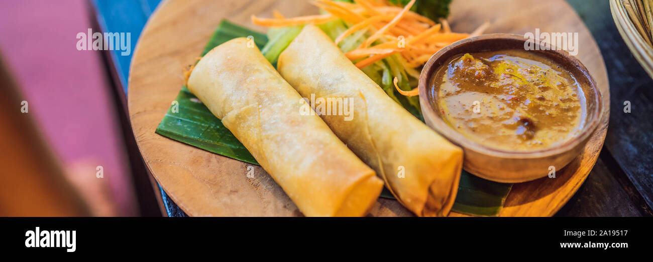 Fried spring rolls served with salad and sauce. Traditional Indonesian ...
