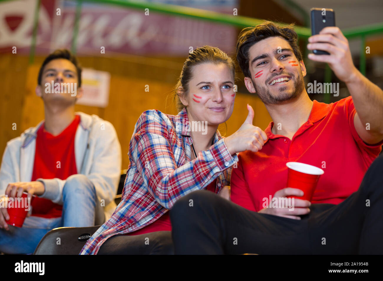 couple fans on stadium taking selfie Stock Photo - Alamy