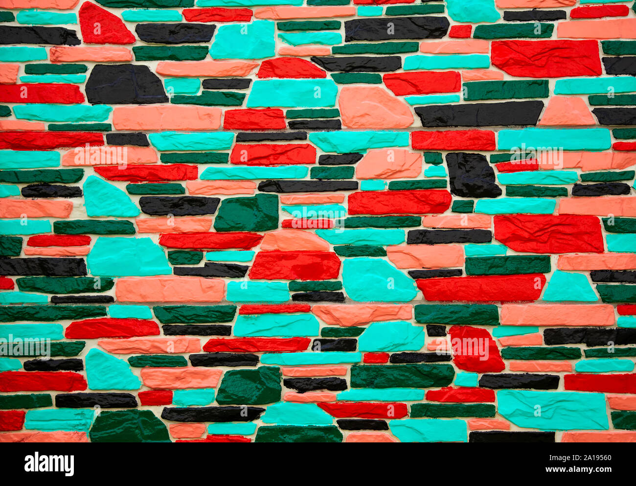 Multicolor red and black brick wall close up Stock Photo - Alamy