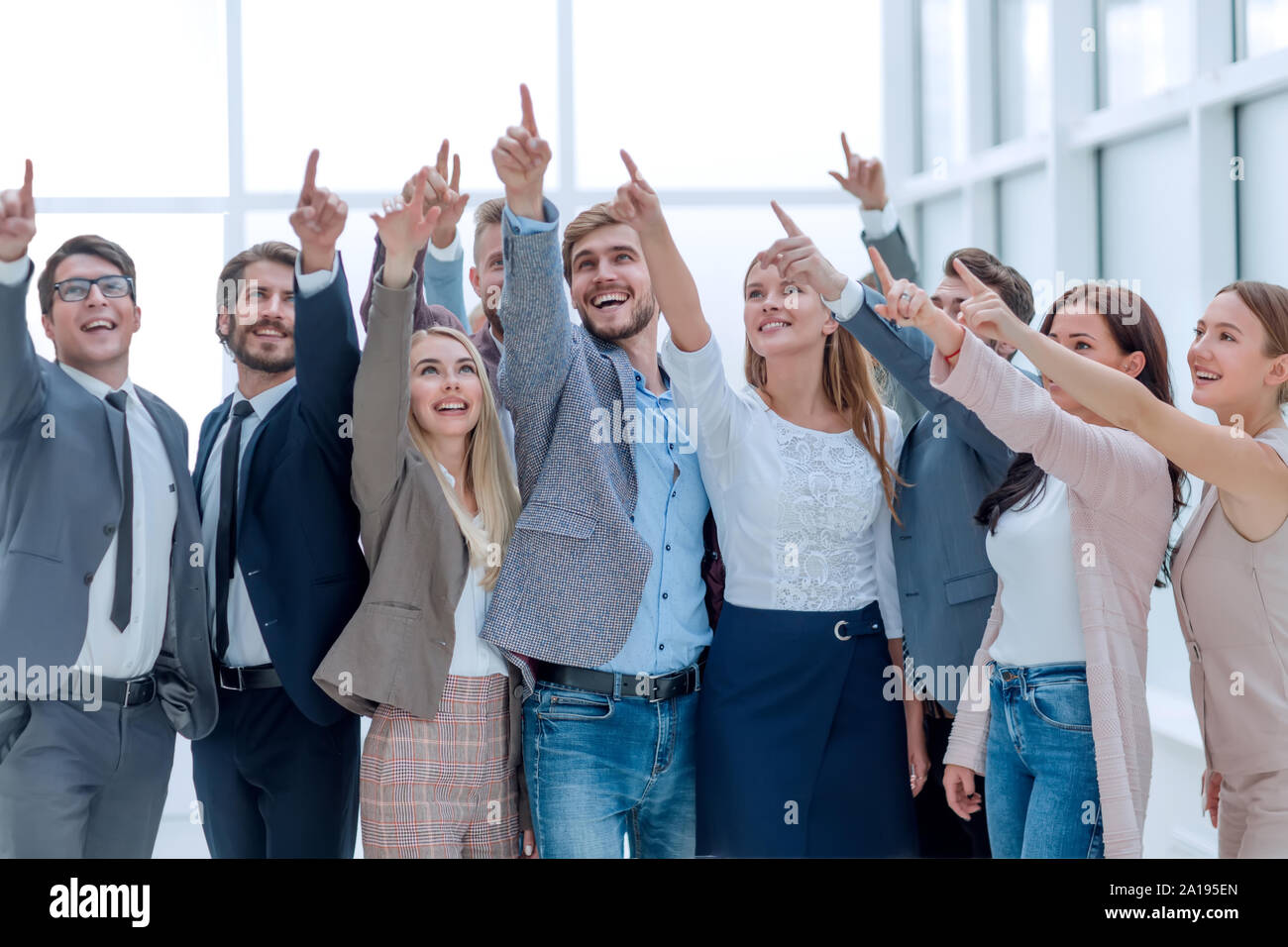 close up. group happy young people, pointing far the upward Stock Photo ...