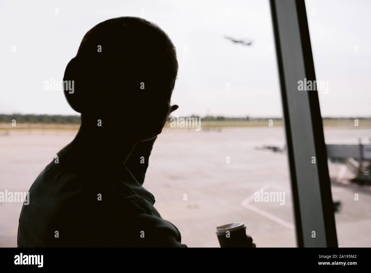 silhouette of woman waiting for flight aircraft. Airline passenger girl ...