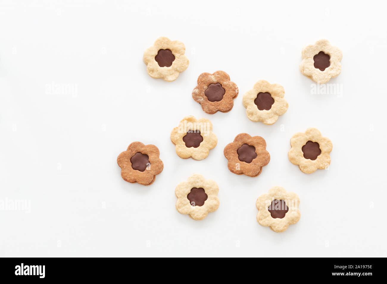 Homemade shortbread cookies layered with milk chocolate, lie on a white ...