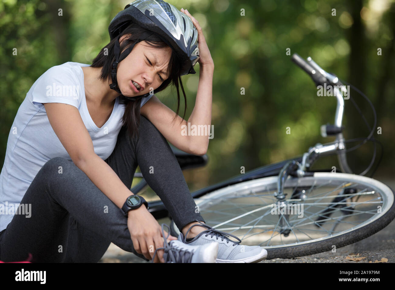 young woman fell from her bike Stock Photo - Alamy