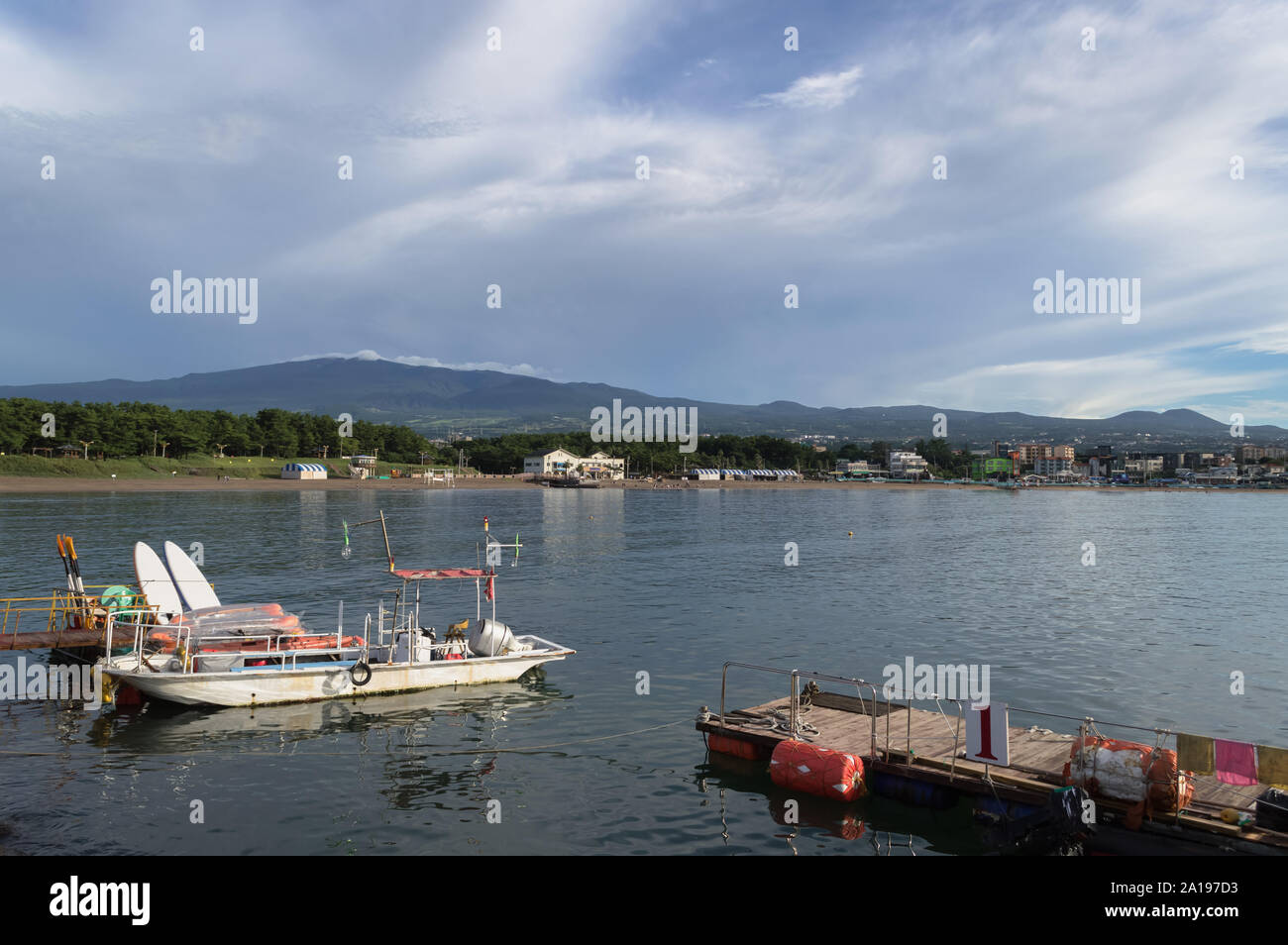 moored boat and pier near Iho Tewoo Beach on Jeju island with scenic ...