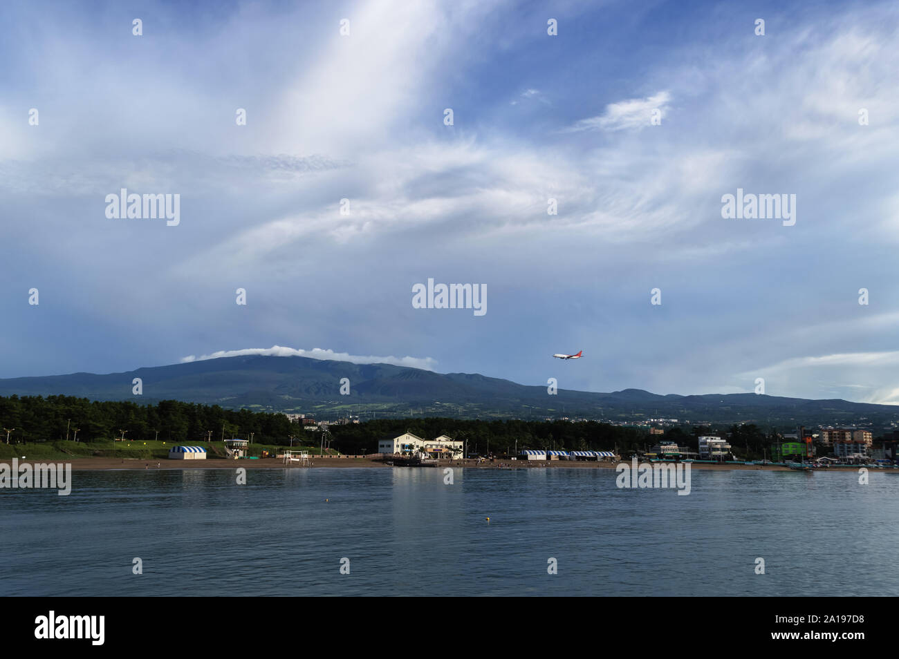 airplane flying over Iho Tewoo Beach on Jeju island with Hallasan ...