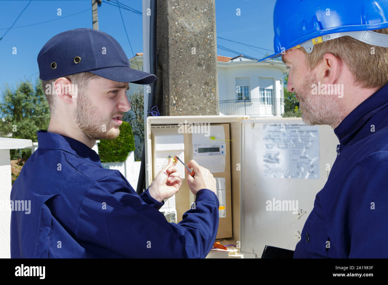 two experienced industrial technicians checking transformer Stock Photo ...
