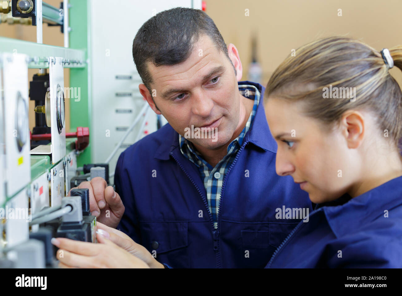 female and male technician repairing system Stock Photo - Alamy