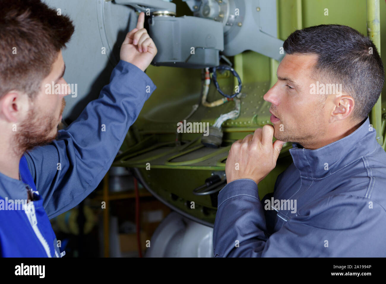 portrait of team solving engine problem Stock Photo - Alamy