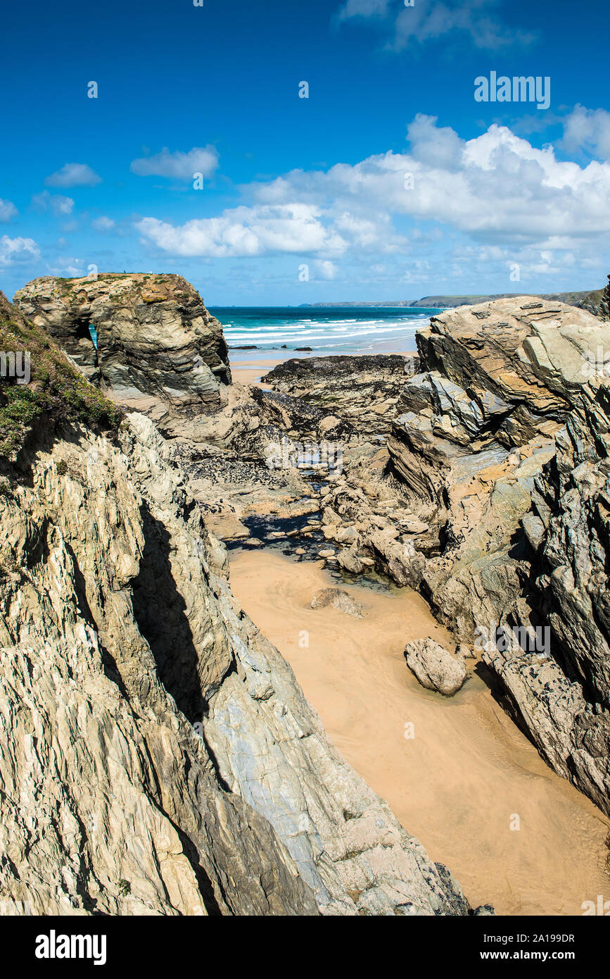 A spring tide exposing rocks on Whipsiderry Beach in Newquay in ...