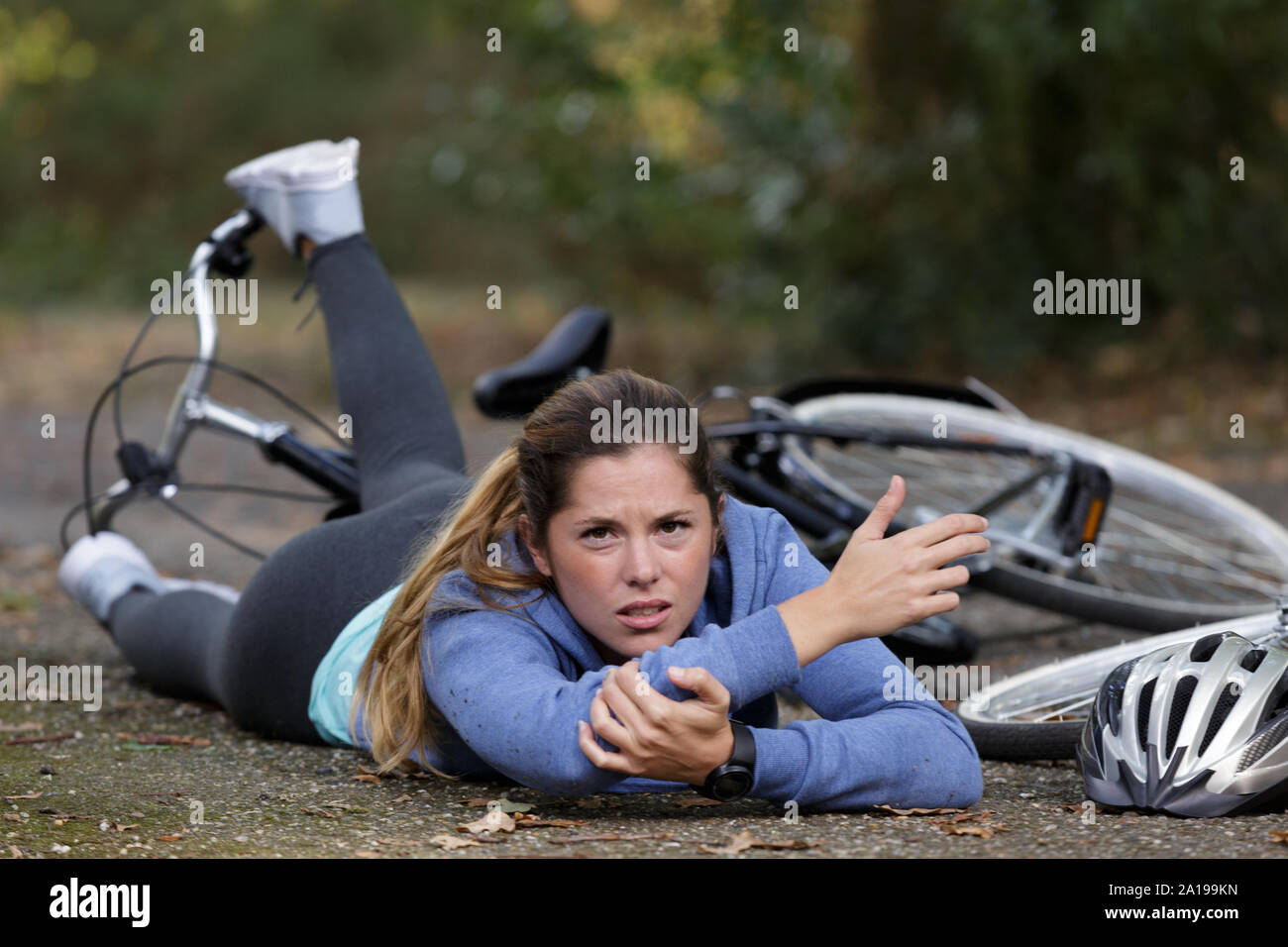 young woman fell from the bike Stock Photo - Alamy