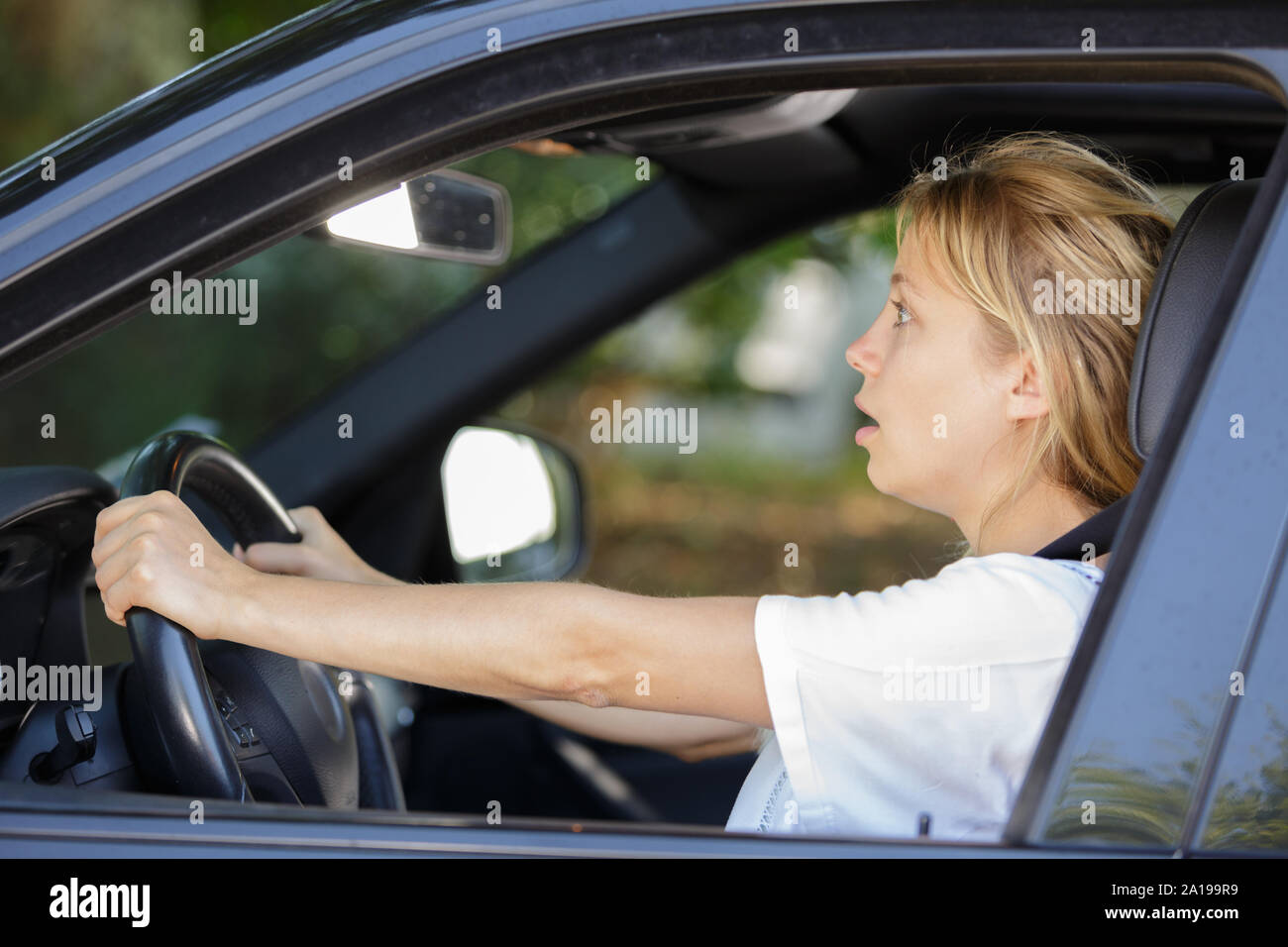 female driver with shocked expression Stock Photo - Alamy