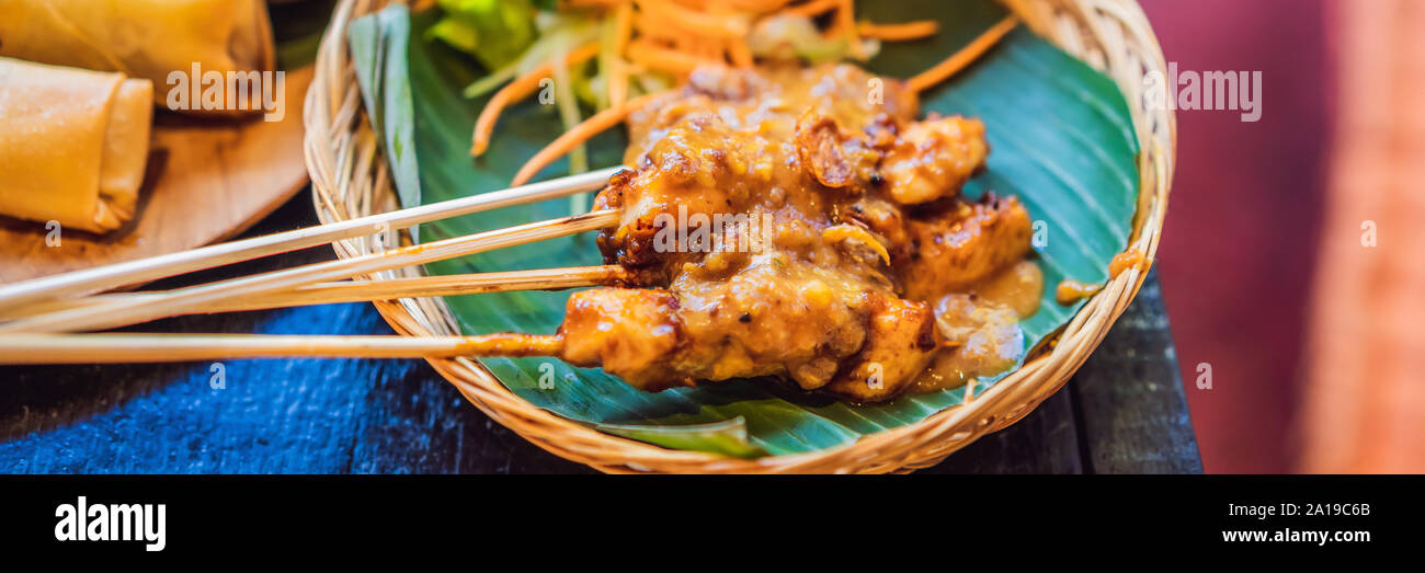 Satay or sate, skewered and grilled meat, served with peanut sauce ...