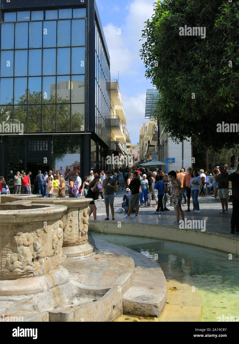 Tourists and locals walking along Four Lions square and Daidalou street ...