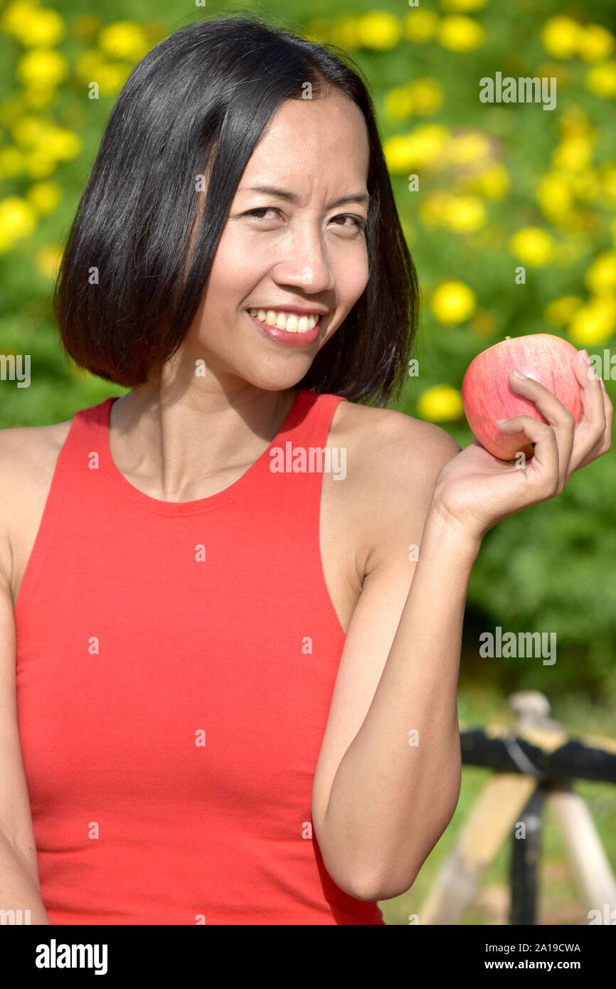 Pretty Female Smiling With An Apple Stock Photo - Alamy