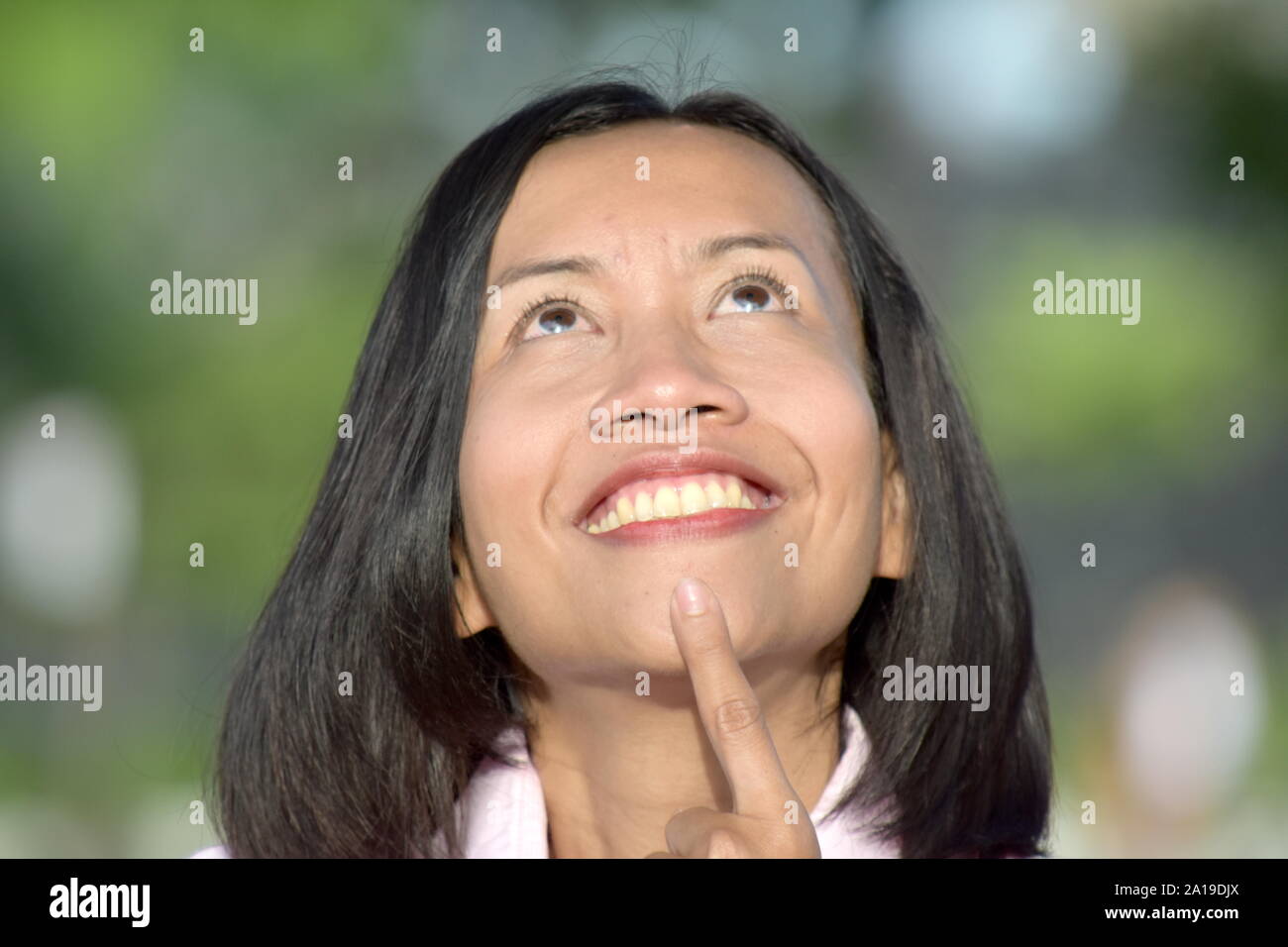 An Attractive Asian Woman Deciding Stock Photo - Alamy