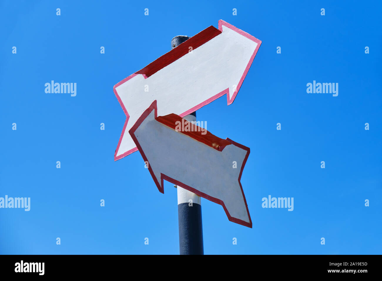 Blank arrow signs with two arrows pointing in different directions, on ...