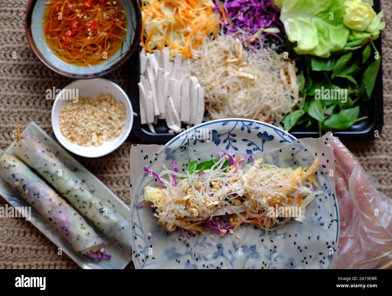 Top view people hand making vegan rice paper rolls, Vietnamese spring ...