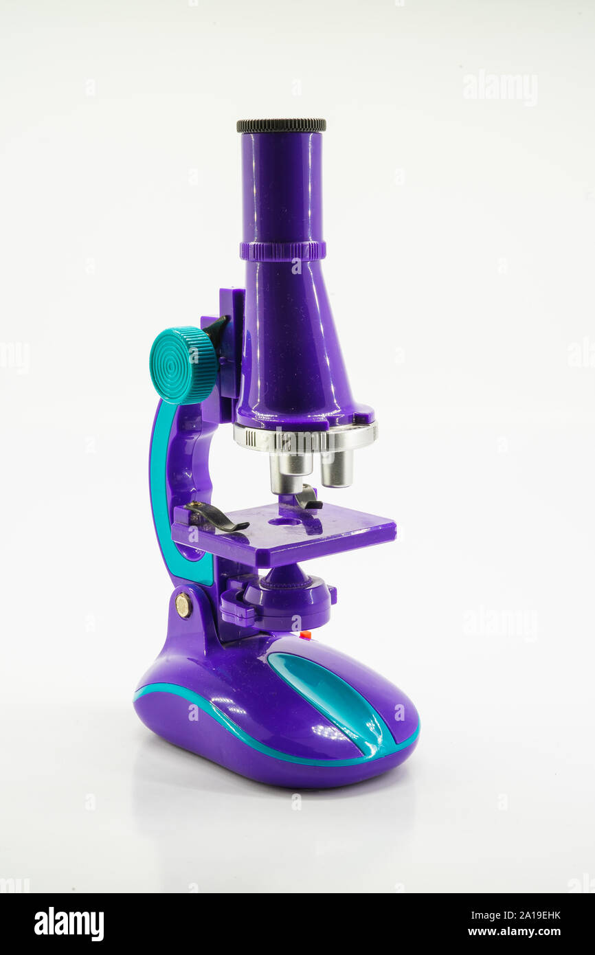 Purple microscope isolated on white Stock Photo - Alamy