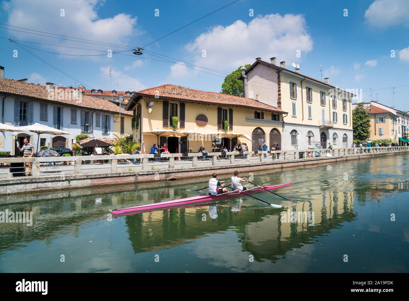 Milan, Italy: Rowers on the Naviglio Grande water canal on a sunny day ...