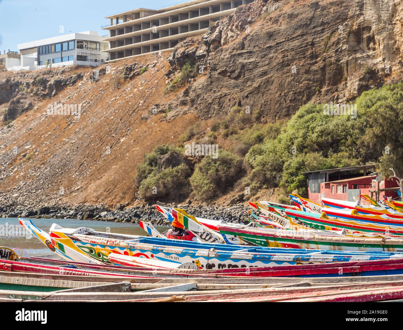 Dakar, Senegal - February 2, 2019: Colored, wooden, fisher boats next ...