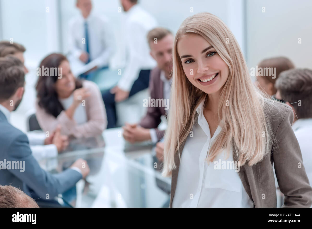 close up. smiling young employee standing in the office Stock Photo - Alamy