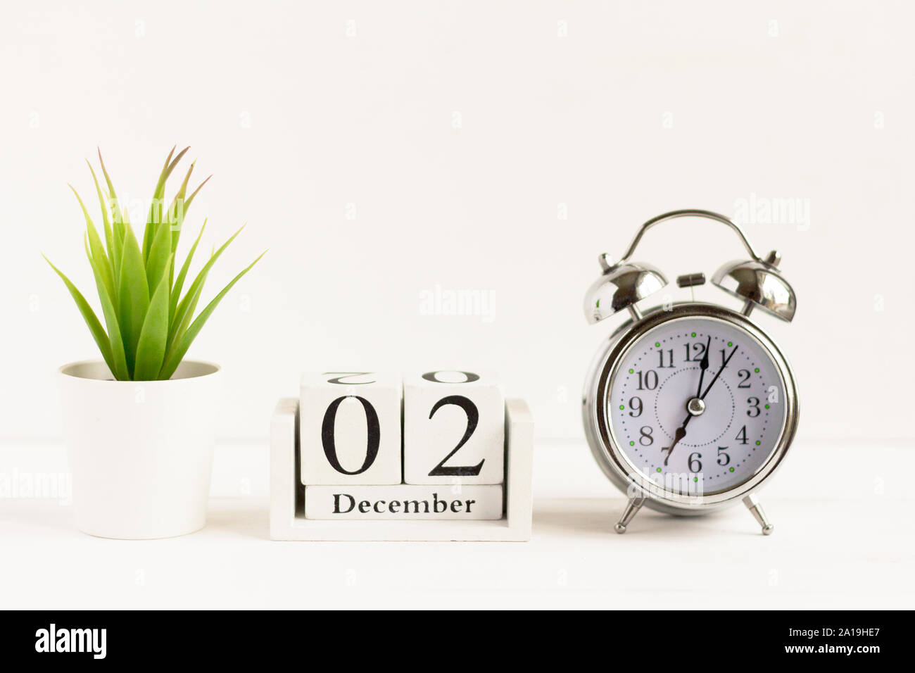 the second of December on the wooden calendar next to the alarm clock ...