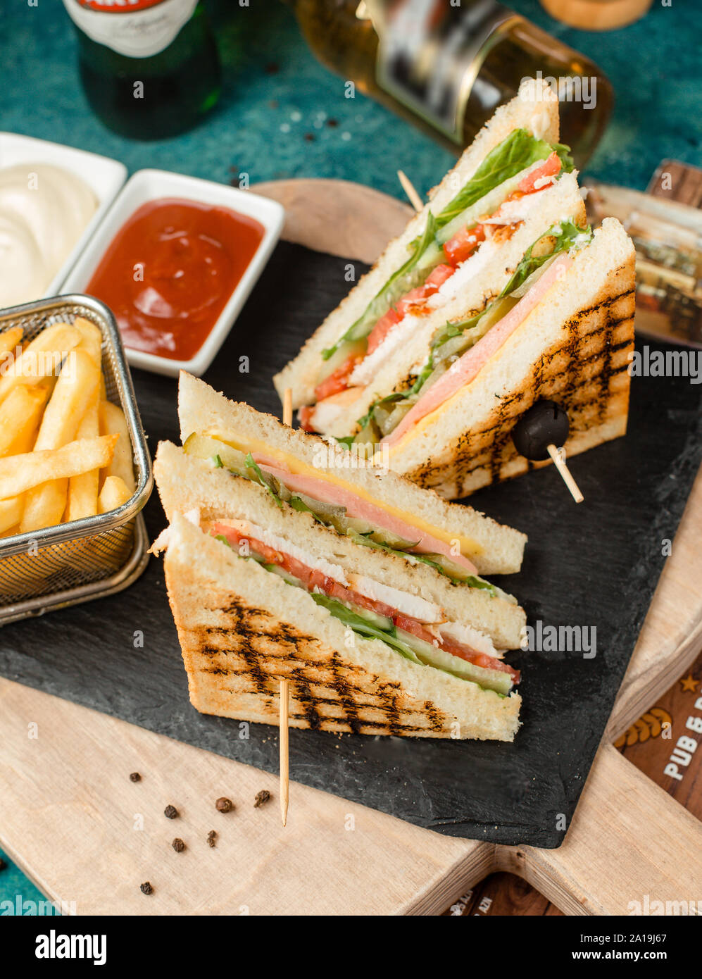 Classic club sandwich with fries and sauce Stock Photo - Alamy