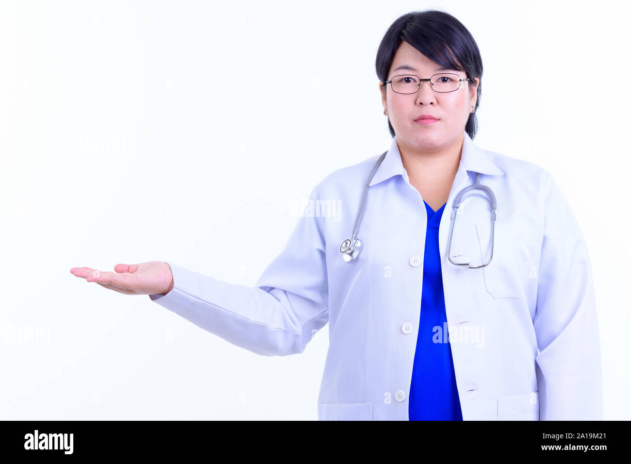 Beautiful overweight Asian woman doctor showing something Stock Photo ...