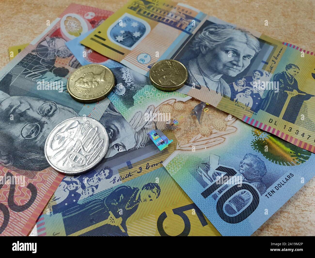 Pile of banknotes and coins Stock Photo - Alamy