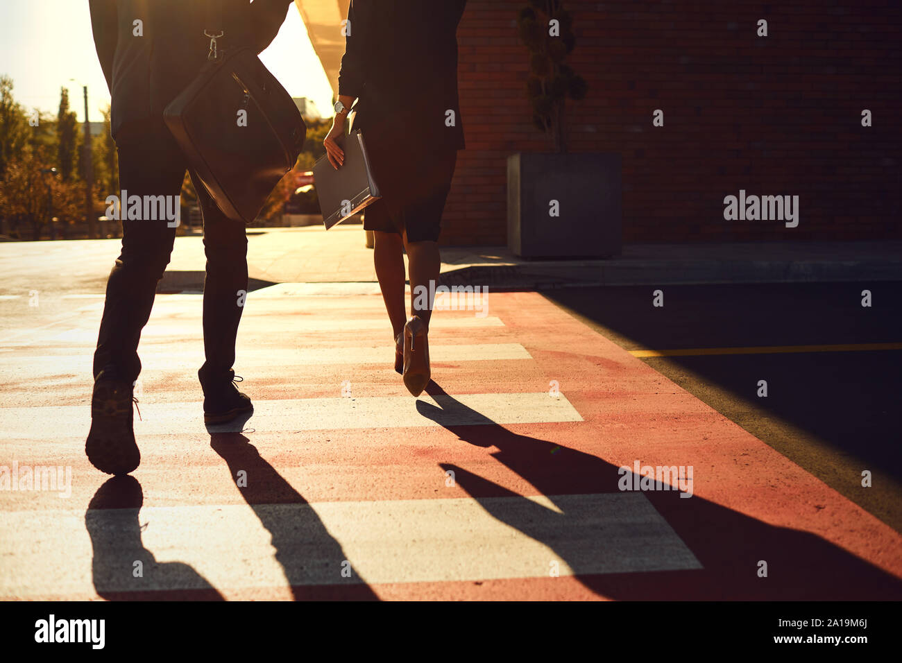 Back view. Business People walk along the city street Stock Photo - Alamy