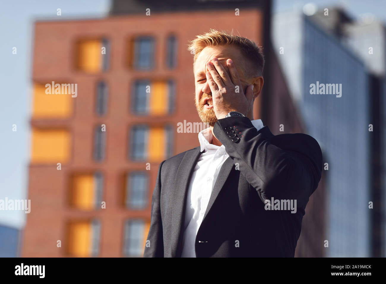 Crisis concept stress problem. Businessman covered his face with his ...