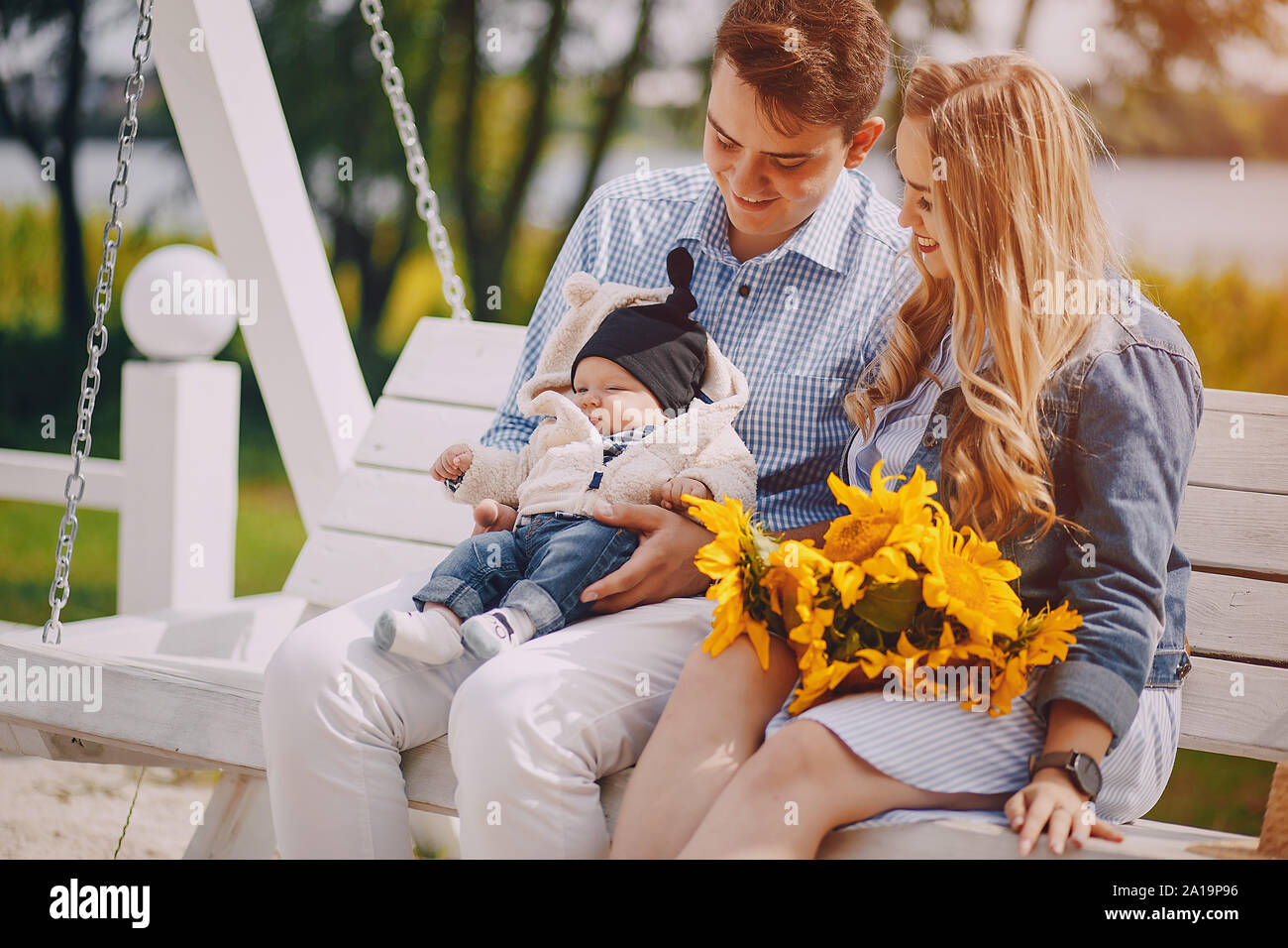 Small blonde girl sitting on swing hi-res stock photography and images - Alamy